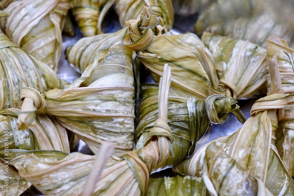 Ketupat daun palas or rice dumpling where glutinous rice is wrapped in ...
