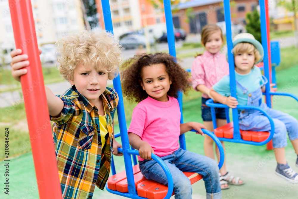 Multicultural Kids Playing On Playground