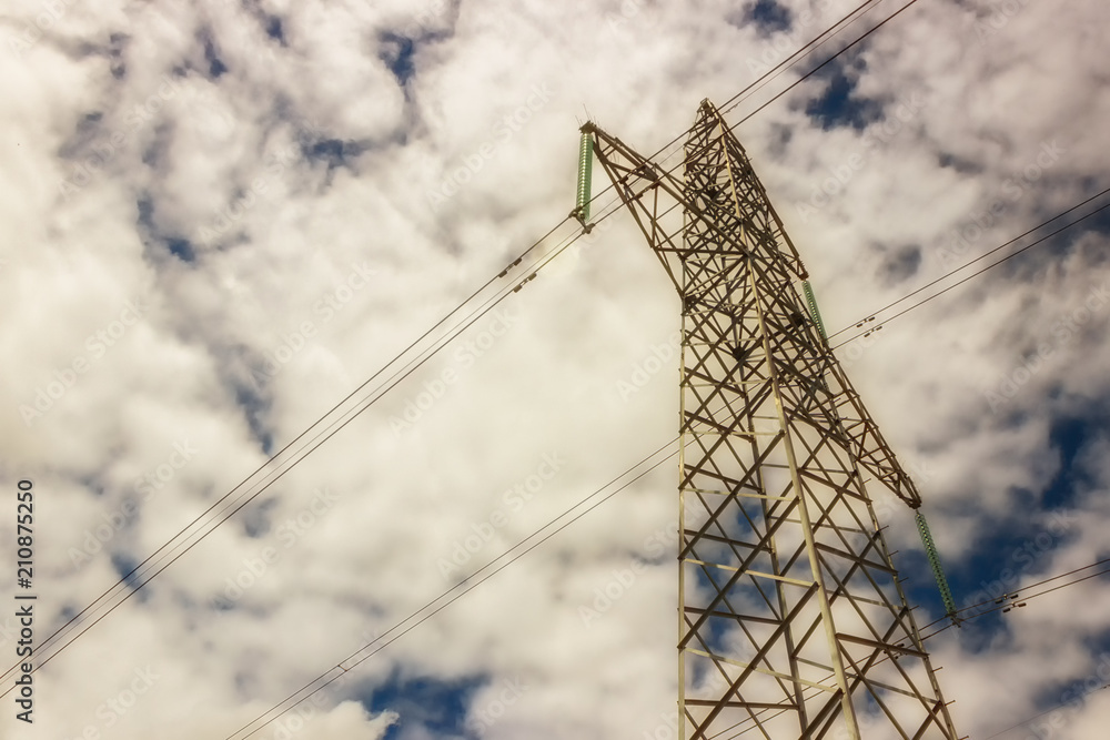 Power pylons and high-voltage lines against the background of the ...
