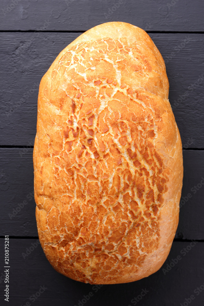 White bread on dark boards, fresh pastry from above, wheat bread from a ...