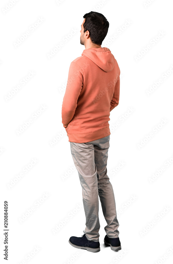Full body of Man in a pink sweatshirt looking back on isolated white ...