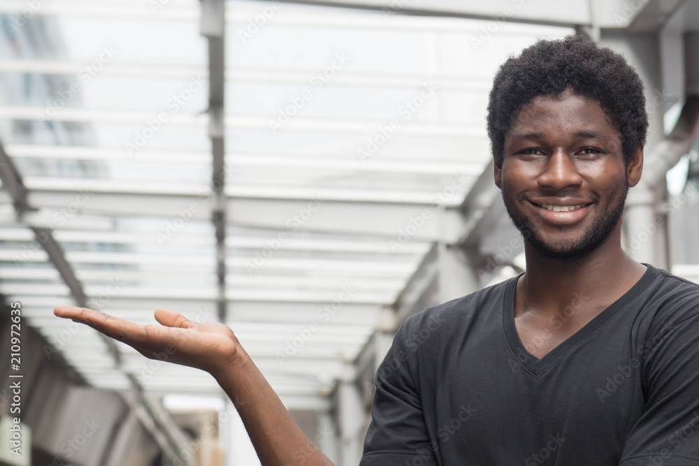 Happy African man pointing; portrait of happy smiling confident young ...