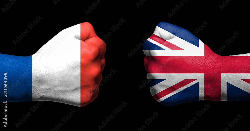 Flags of France and Unied Kingdom painted on two clenched fists facing ...