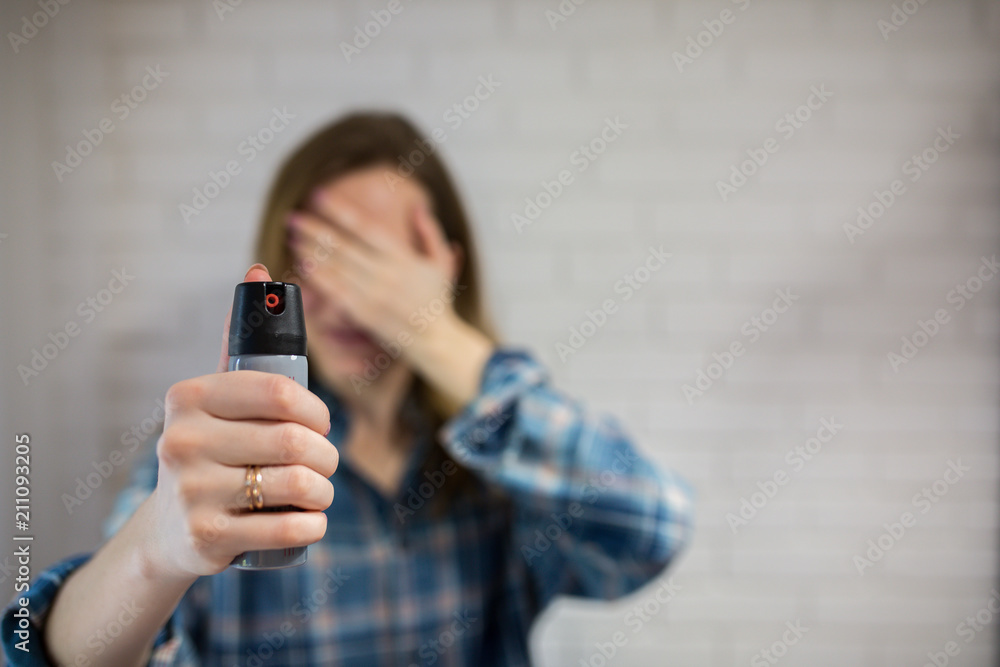 Married woman is holding pepper spray canister for personal protection ...