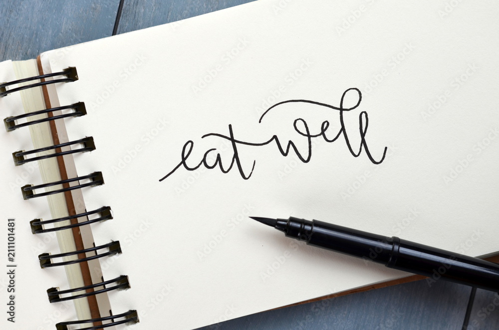 EAT WELL hand-lettered in notepad Stock Photo | Adobe Stock
