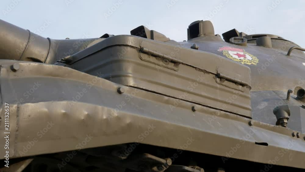 Soviet battle tank on a pedestal in a park with military equipment ...