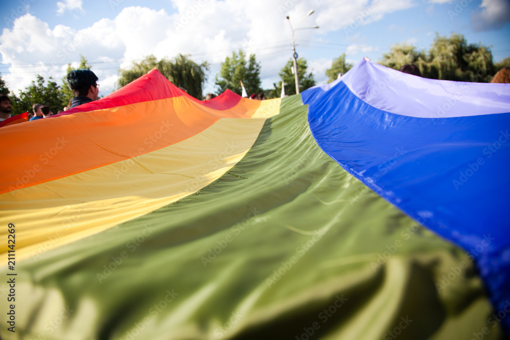 people holding giant rainbow flag at pride parade - LGBT symbol Stock ...