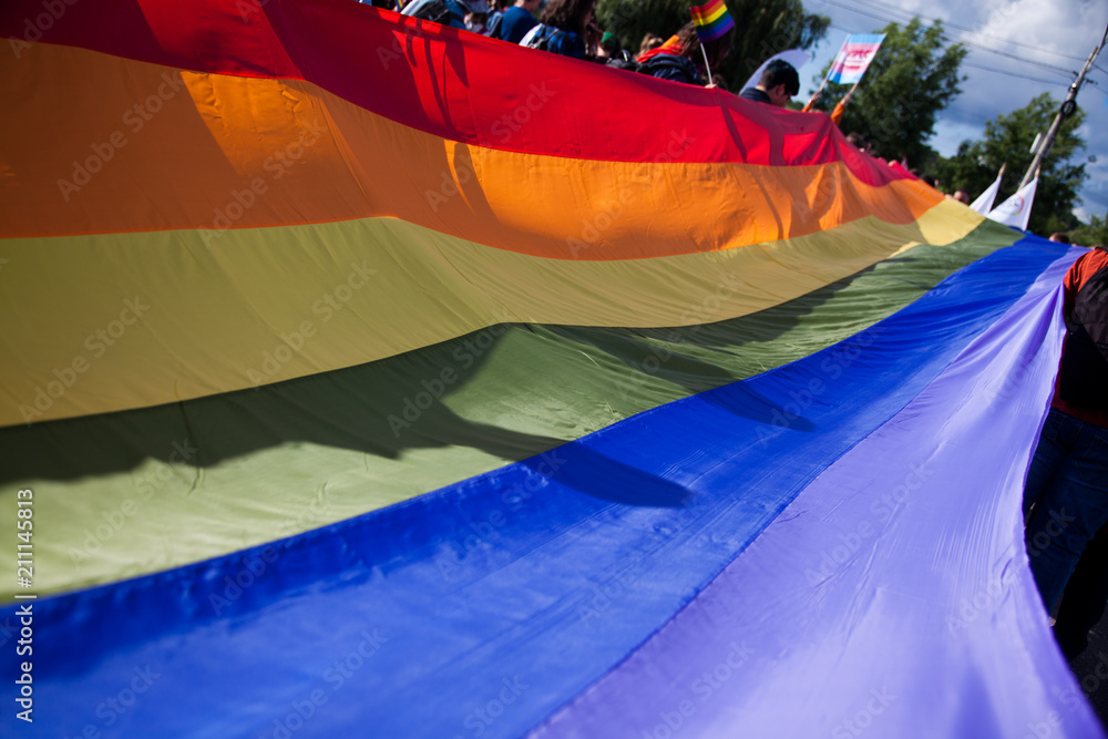 people holding giant rainbow flag at pride parade - LGBT symbol Stock ...