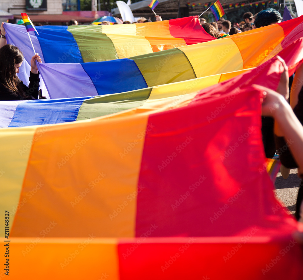 people holding giant rainbow flag at pride parade - LGBT symbol Stock ...