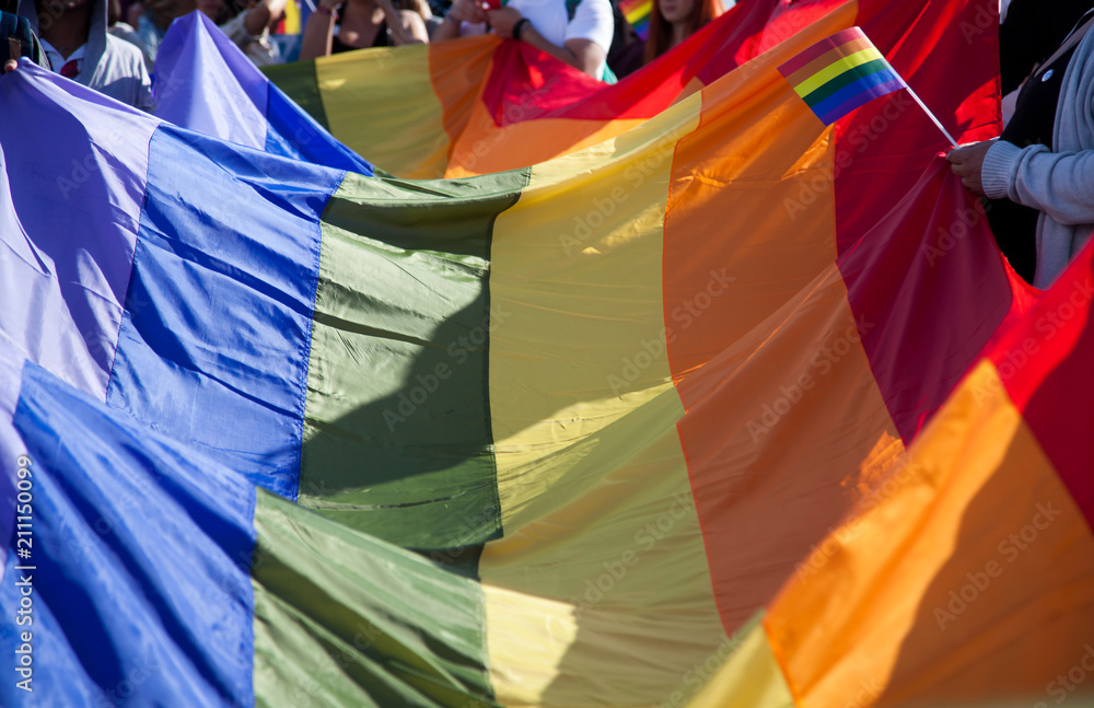 people holding giant rainbow flag at pride parade - LGBT symbol Stock ...