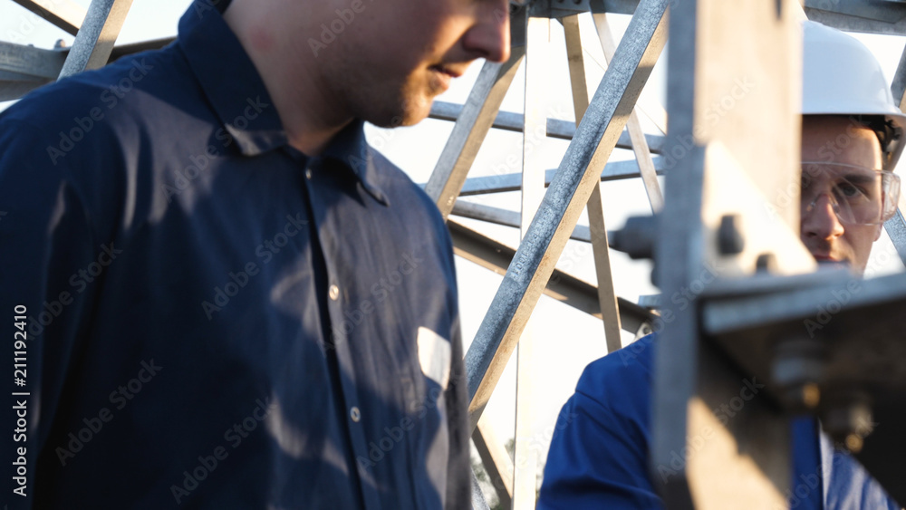 An electrician or builder and engineer, in a blue robe, in a yellow and ...