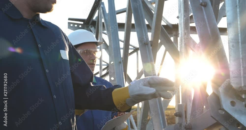 An electrician or builder and engineer, in a blue robe, in a yellow and ...
