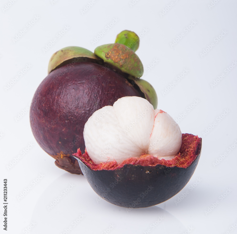 Mangosteen fruit and cross section showing the thick purple skin and ...