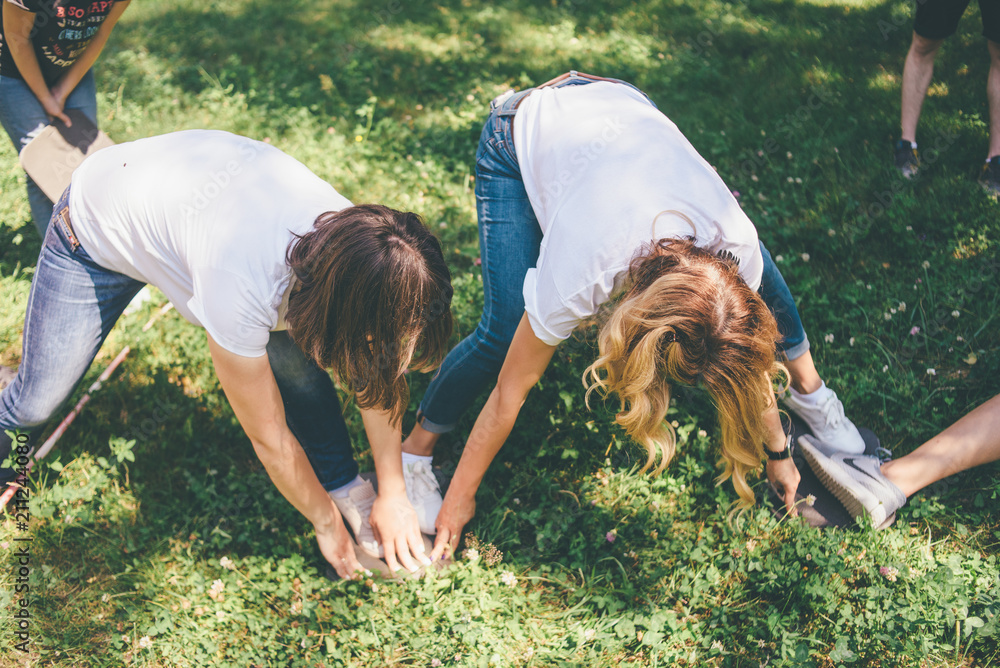 teambuilding exercises holding hands and legs Stock Photo | Adobe Stock