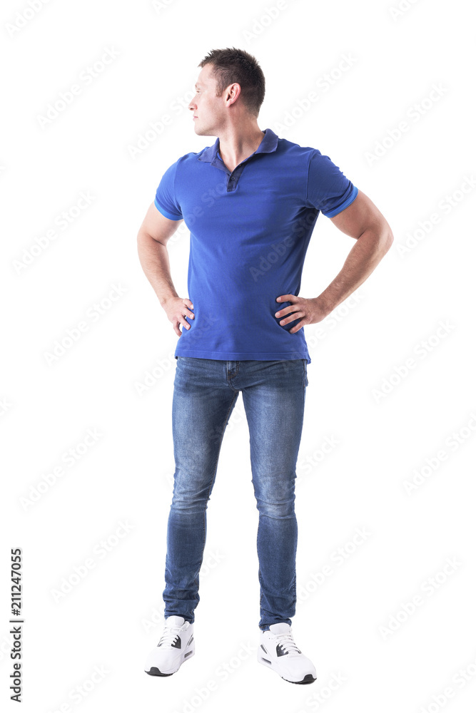 Handsome fit casual adult man in blue polo shirt with arms on hips ...