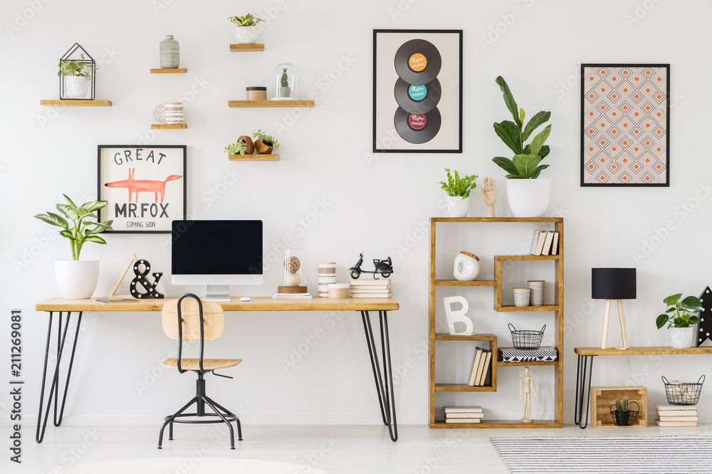 Real photo of a desk with a computer screen, ornaments and a plant ...