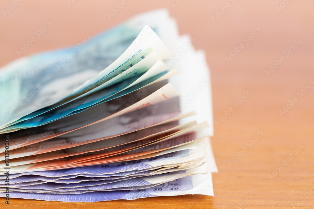 Pile of various british bank notes on a table Stock Photo | Adobe Stock