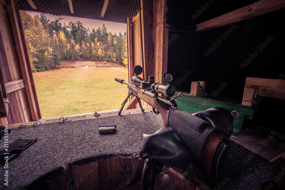 Sniper rifle with silencer and scope at shooting range Stock Photo ...