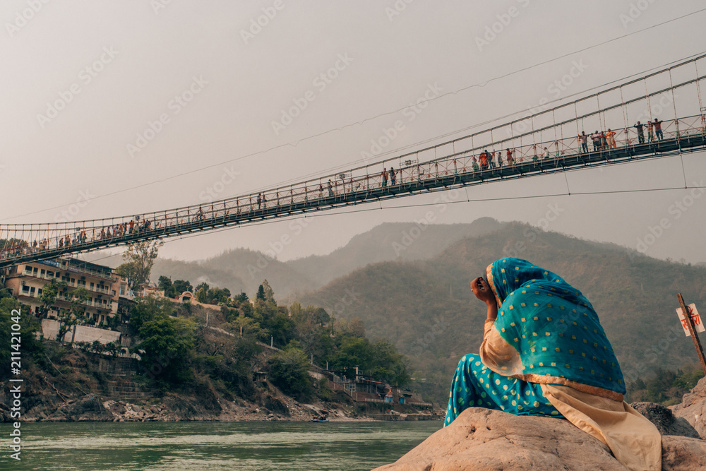 an indian woman crying in front of a bridge Stock Photo | Adobe Stock