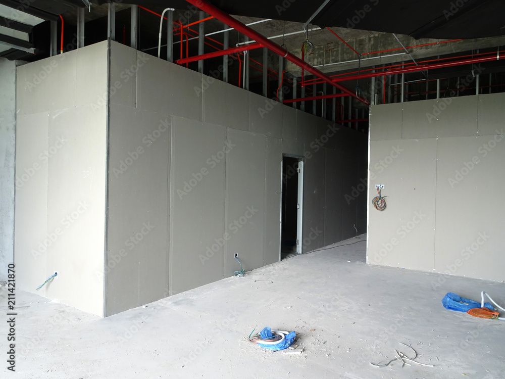 Drywall installation work in progress by construction workers at the ...