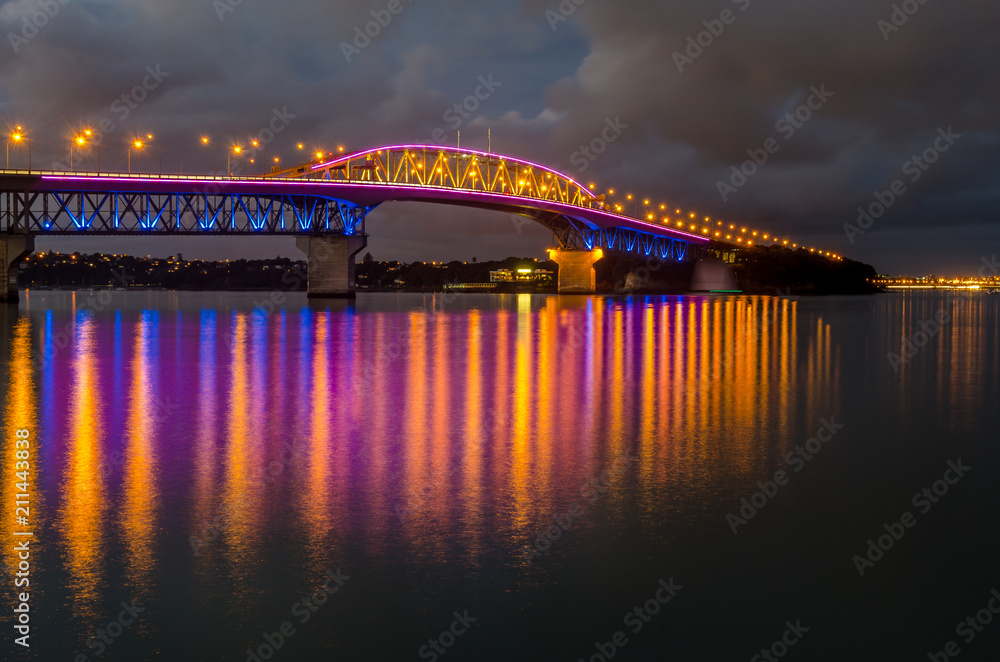 Auckland harbour bridge at night lit up in bright colours. Stock Photo ...