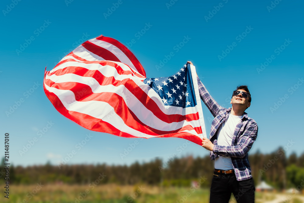 Happy 4Th Of July card. man is holding waving american USA flag, toned ...