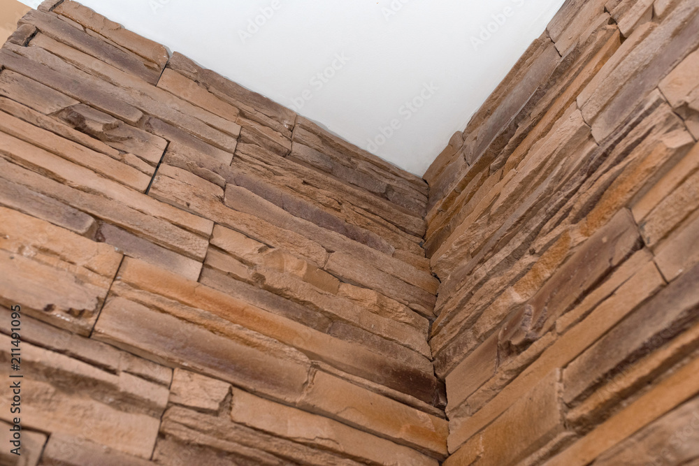 Sample of a decorative stone wall. Details of the corner ceiling ...