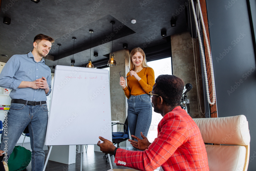 Two young businesswoman preparing a presentation standing together in ...
