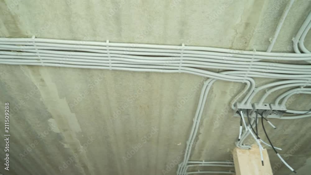 Electrical installation of plastic tubes on building site. Fix boxes ...