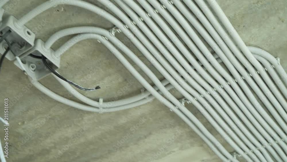 Electrical installation of plastic tubes on building site. Fix boxes ...