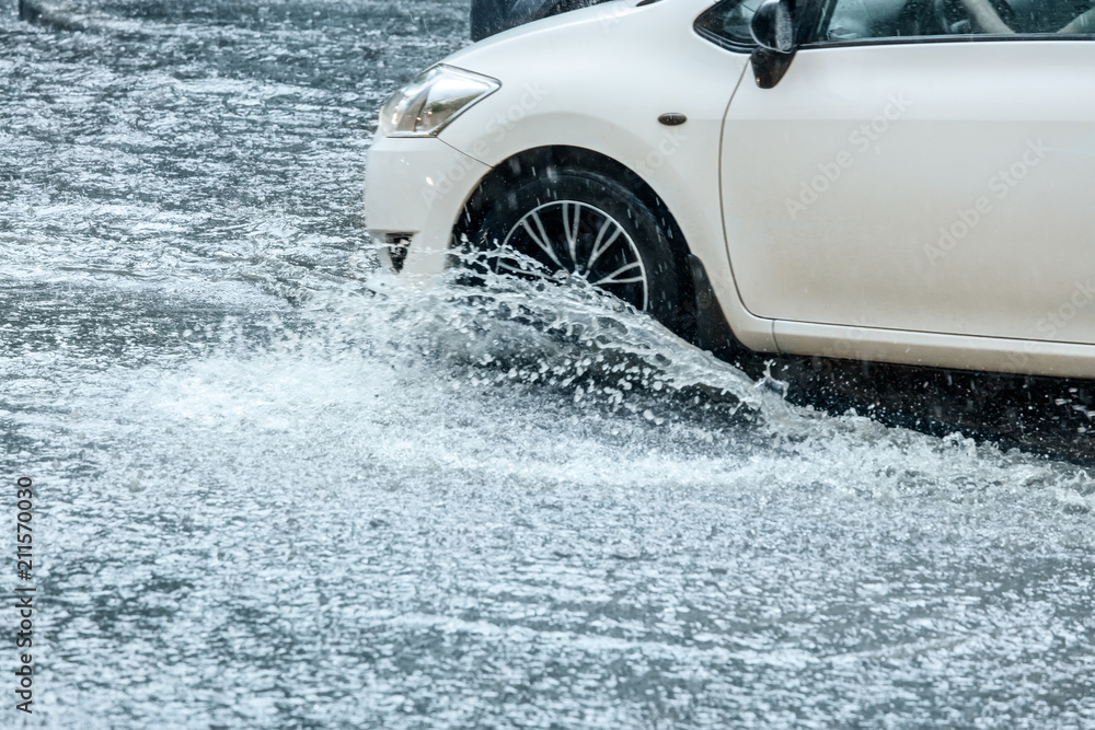 city road during bad weather. rain water spraying from car wheels Stock ...