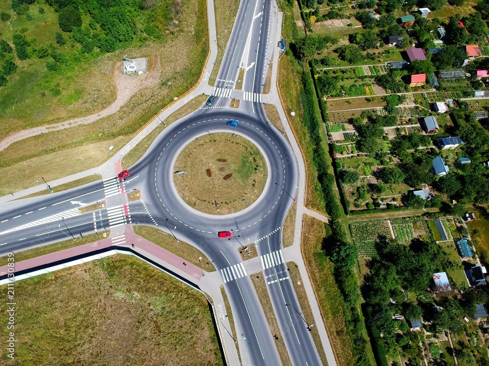 Roundabout intersection in three directions with island, aerial view ...