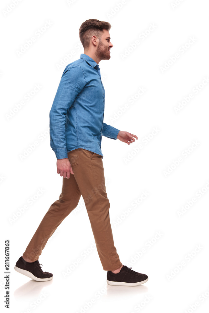 side view of handsome casual man walking Stock Photo | Adobe Stock