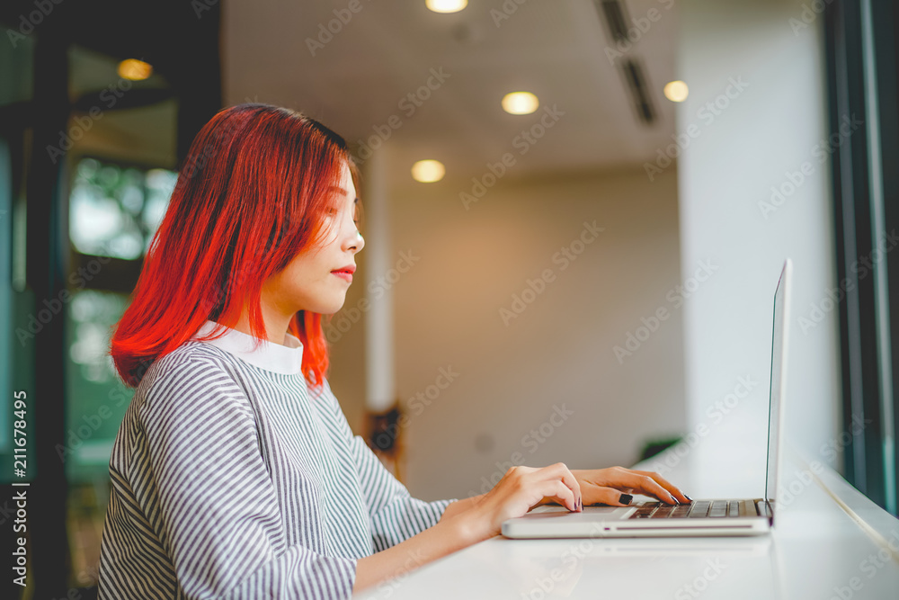 Pretty girl student studies with laptop in university campus | Side ...