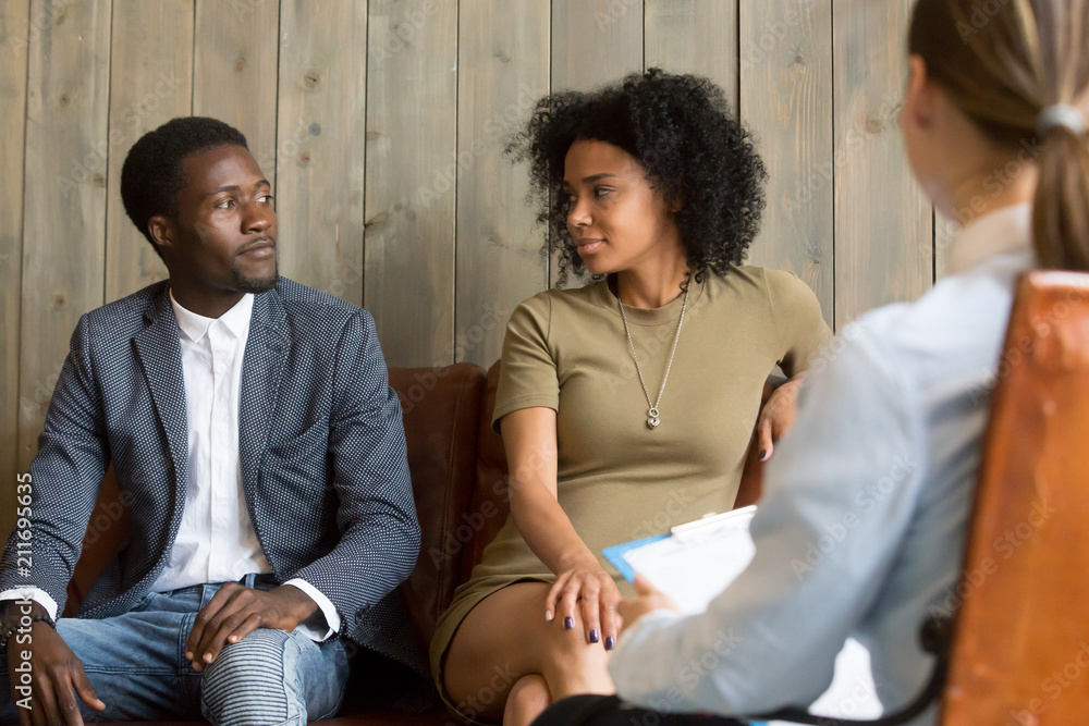 Reconciled black husband and wife looking at each other after ...