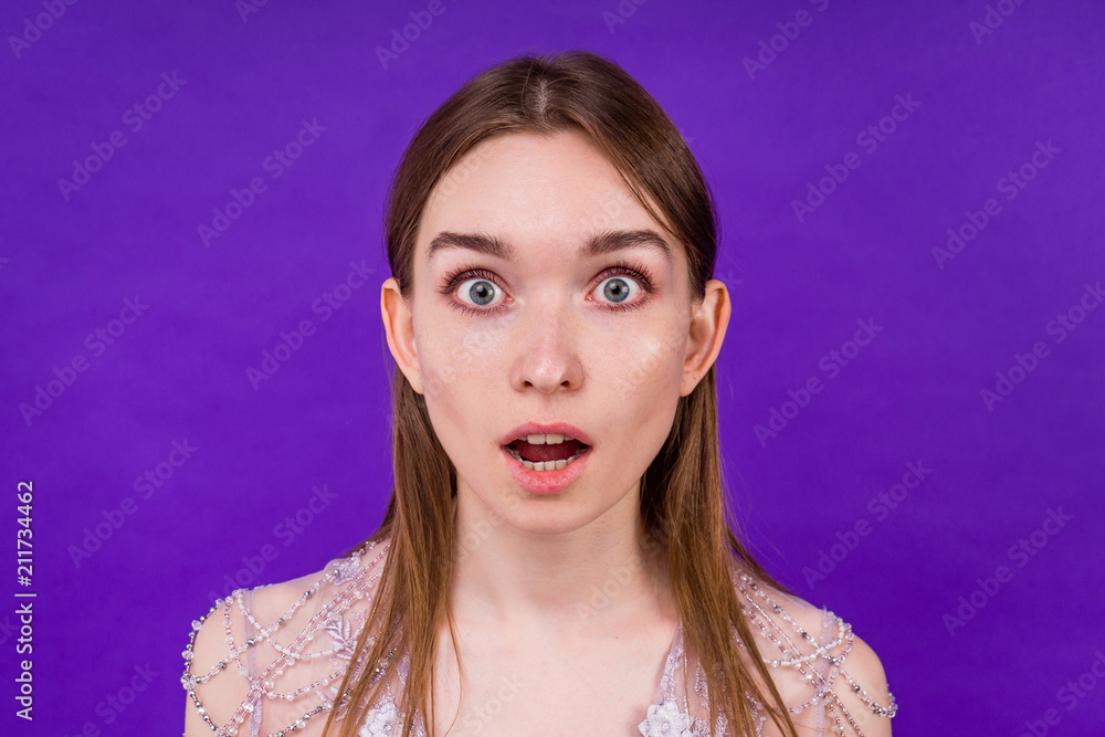 beautiful young woman with big ears and huge eyes on purple background ...