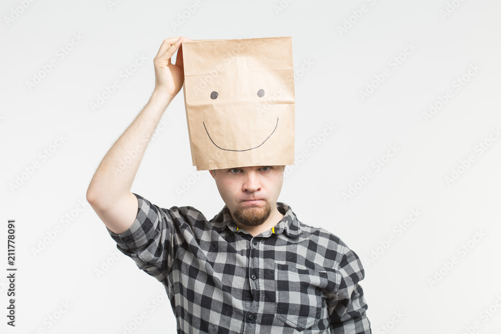 Angry white men wearing happy paper bag mask on white background Stock ...