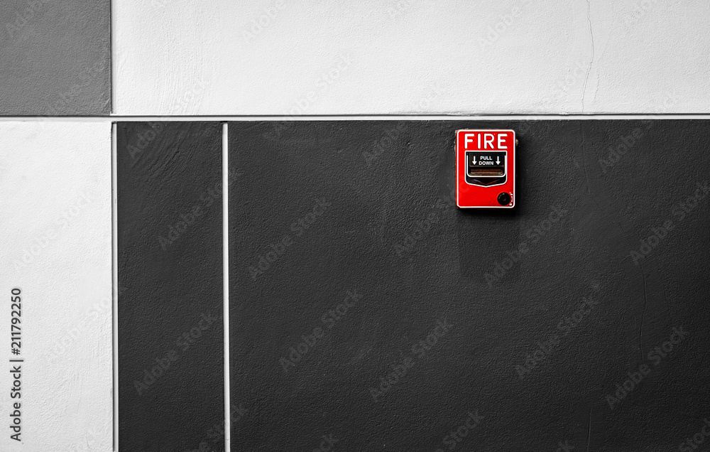 Fire alarm on black and white concrete wall. Warning and security ...