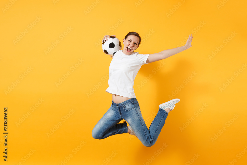 Young fun expressive European woman football fan jumping in air, cheer ...