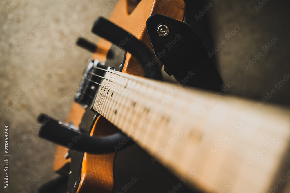Details of an orange electric guitar with a vintage style seen from the ...