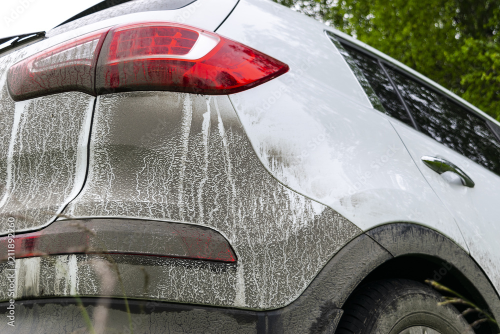 Back view of a very dirty car. Fragment of a dirty SUV. Dirty ...