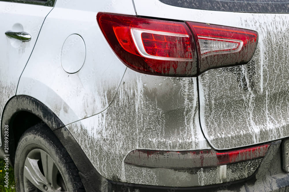 Back view of a very dirty car. Fragment of a dirty SUV. Dirty ...