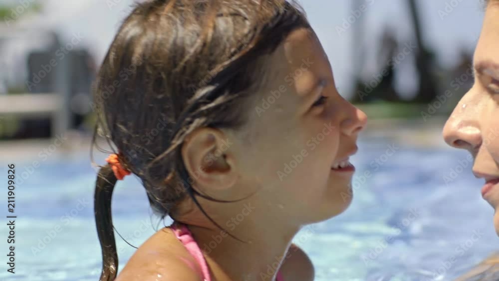 Closeup of happy little girl laughing and smiling while chilling in ...