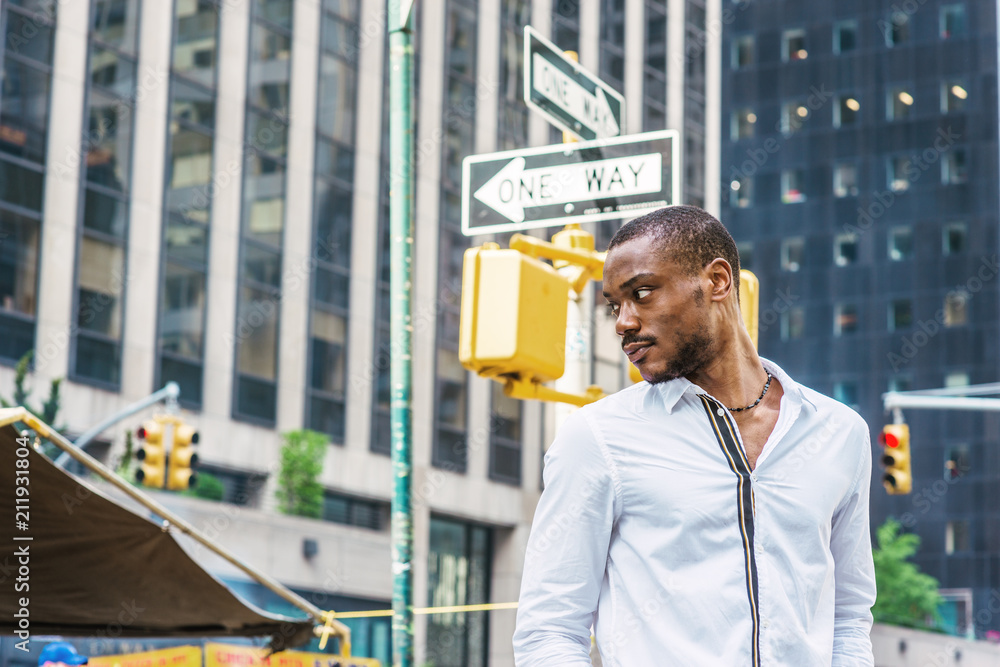Young African American Man, wearing white shirt, standing at ...