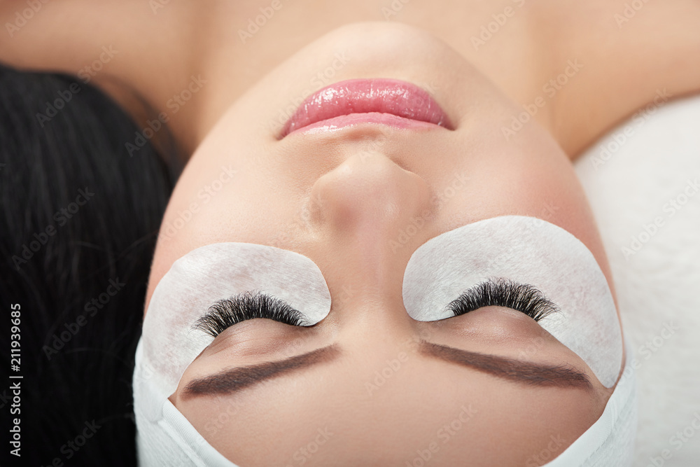 Photo comparison of woman's normal and fake enlarged lashes. Client ...