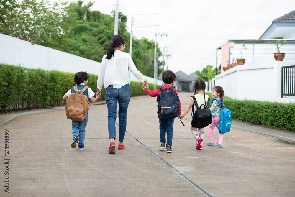 Group of preschool student and teacher holding hands and walking to ...