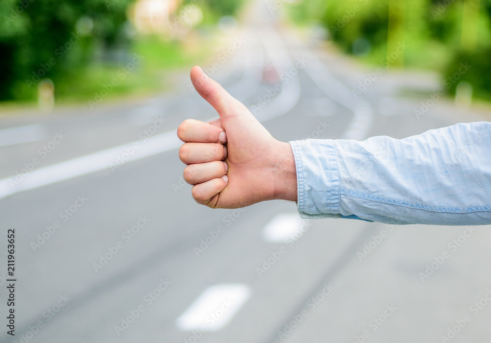 Thumb up gesture try stop car road background. Hand gesture hitchhiking ...