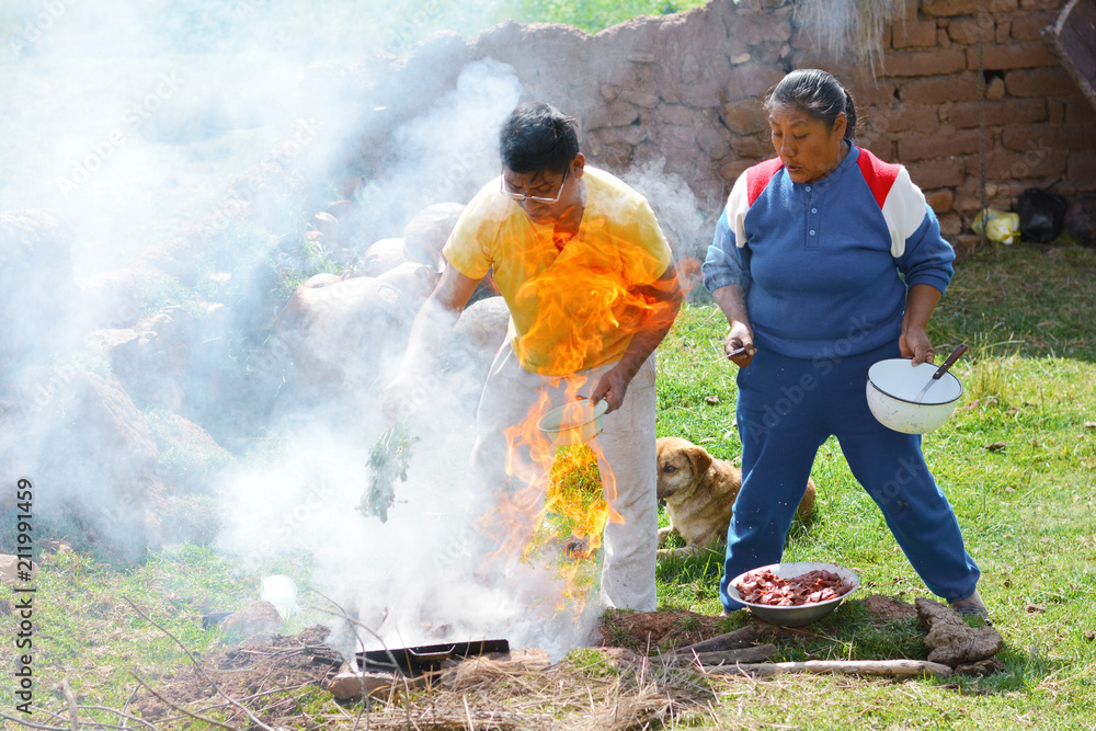 Native american man and woman cooking in the countryside with very ...