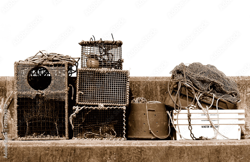 Collection of lobster pots, and boxes on a harbour wall Stock Photo ...