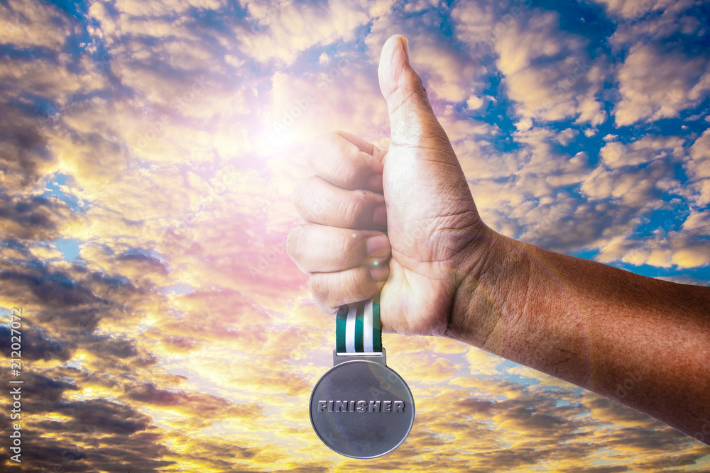 A hand and A golden medal. Hand is holding and the hand is putting the ...